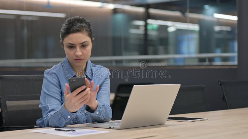 Indian Woman with Laptop Using Smartphone at Work Stock Photo - Image ...