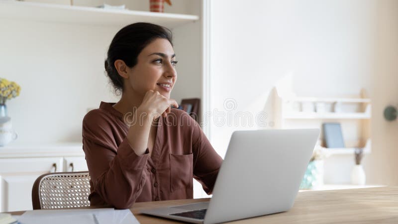 Indian Woman Sit at Table with Laptop Thinking Looks Aside Stock Photo ...