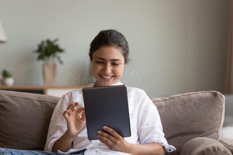 Indian Woman Sits on Sofa with Modern Digital Tablet Device Stock Image ...