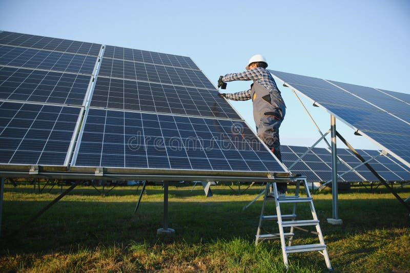 An Indian Worker Installs Solar Panels. the Concept of Renewable Energy ...
