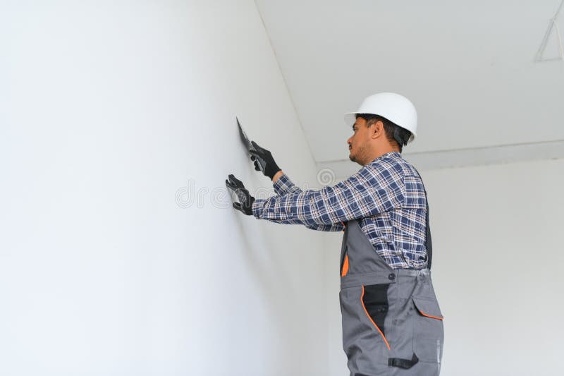 An Indian Worker Works in an Empty Apartment. a Man in a Uniform Makes ...
