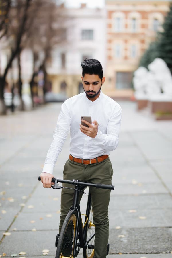 Indian Young Man Using Mobile Phone and Fixed Gear Bicycle in the ...