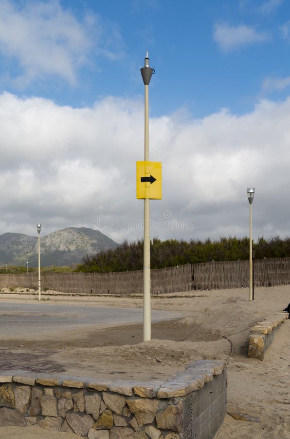 Indication of Direction on a Pole in an Empty Parking Lot Near a Beach ...