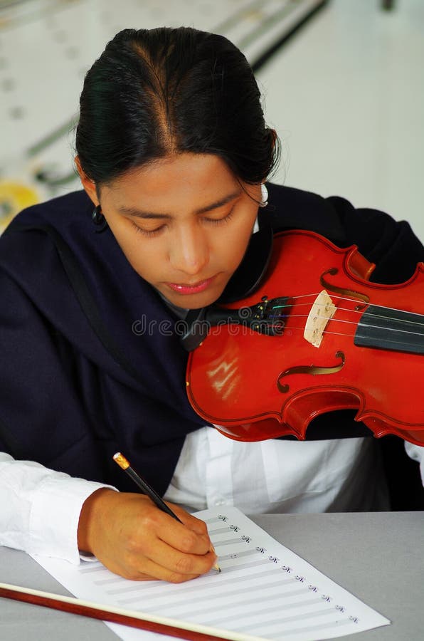 Indigenous Young Man Writing Notes To Music with Violin, Concept of ...