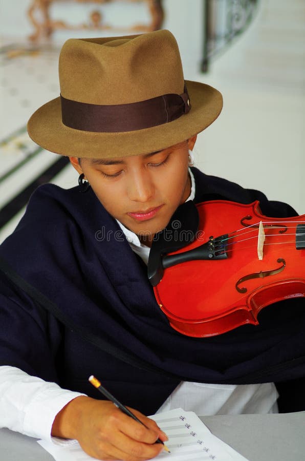 Indigenous Young Man Writing Notes To Music with Violin, Concept of ...