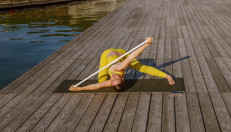 Participating in a Dynamic Yoga Pose on a Beautiful Scenic Dock ...