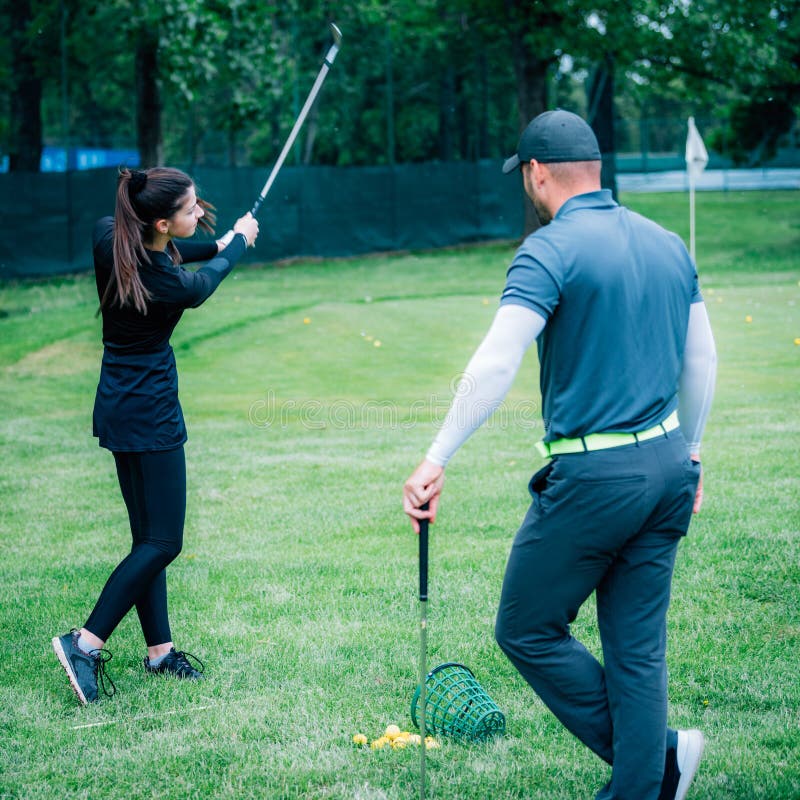 Individual Golf Lesson. Young Woman Having a Golf Lesson with Golf ...