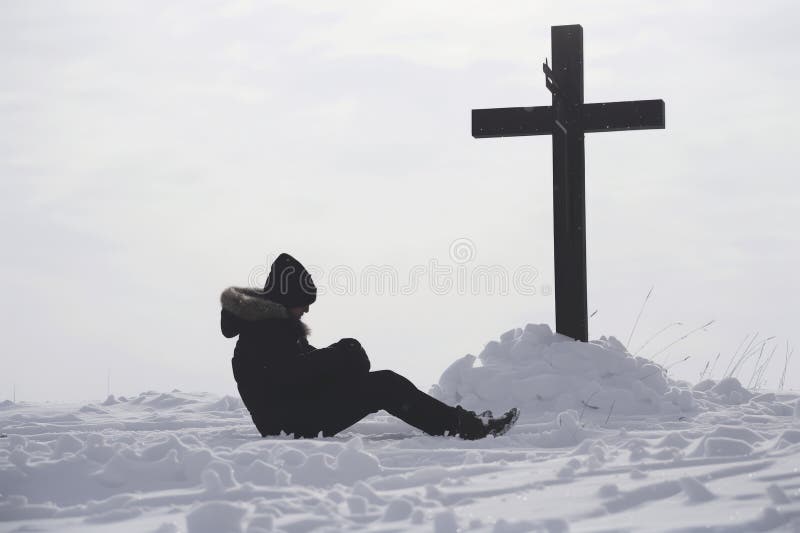 Individual Sitting on Snowy Ground by Cross in Winter Stock Image ...