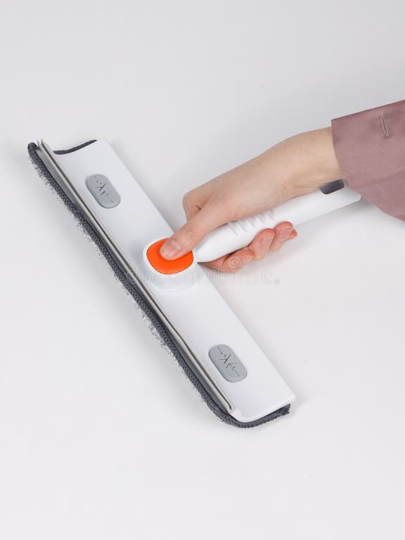 An Individual is Using a Squeegee To Clean a Window Efficiently Stock ...