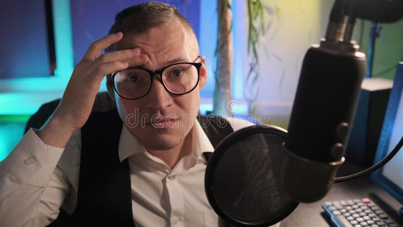 Individual Wearing Glasses Appears Perplexed while Sitting at a Desk ...