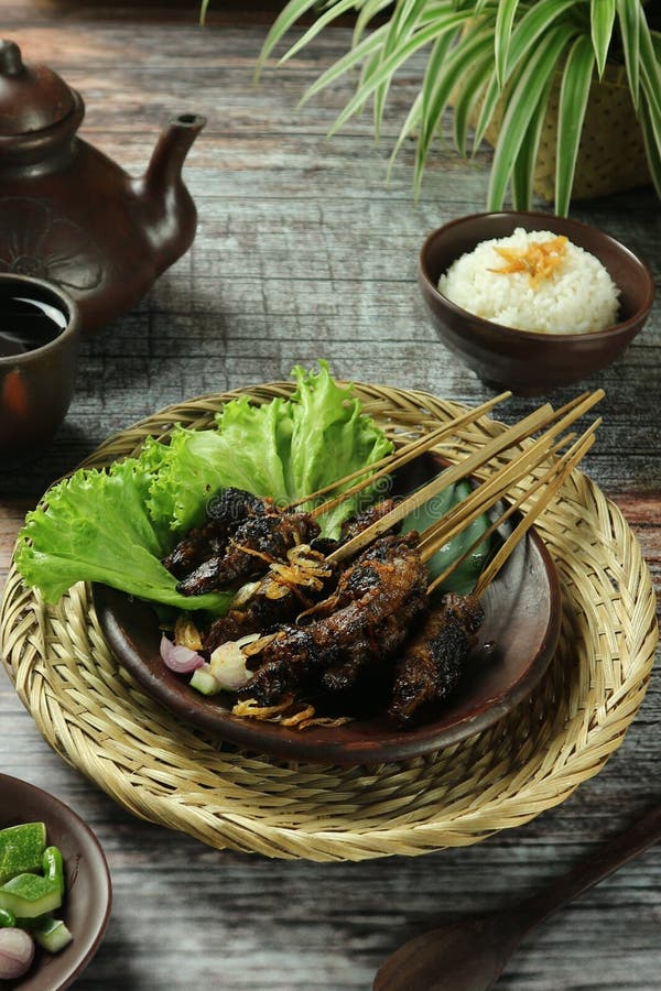 Indonesian Beef Satay Served with Pickles and Lettuce Stock Photo ...