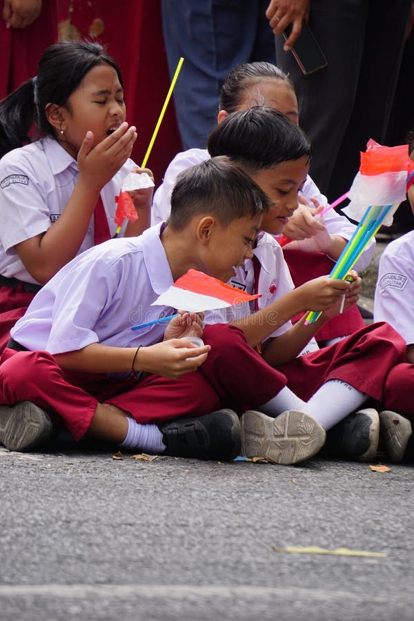 Indonesian Elementary School Students with Their Friends Holding Red ...