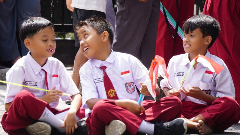 Indonesian Elementary School Students with Their Friends Holding Red ...