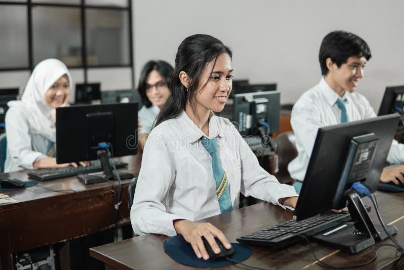 Indonesian Female High School Students Smile while Using a Computer PC ...