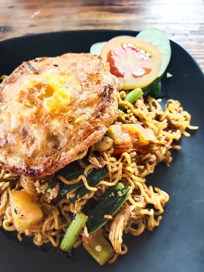 Indonesian Mie Goreng with Extra Egg and Vegetable Stock Photo - Image ...