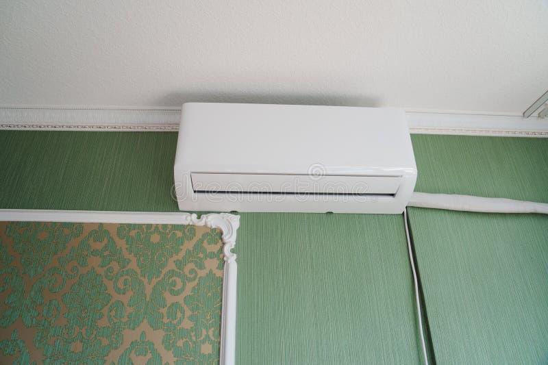 Indoor Air Conditioning Unit on the Wall of the Apartment with Green ...