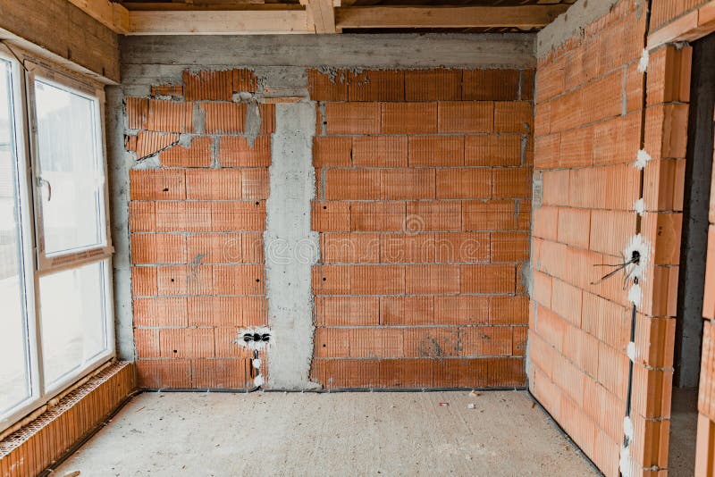 Indoor Construction Site with a Big Window, Brown Bricks and Concrete ...