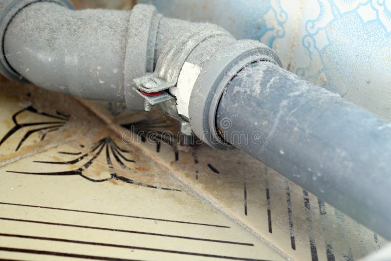 Indoor Plastic Sewer Pipe with Fixing for Floor and Wall. Stock Photo ...