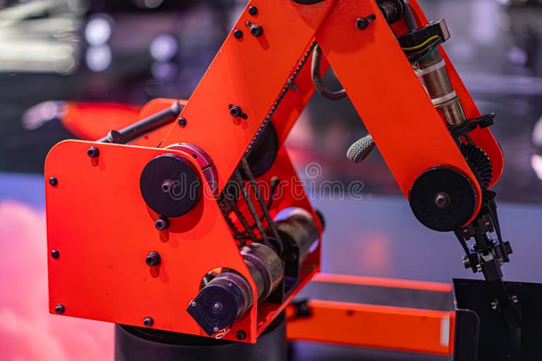 Indoor Scene Featuring a Large, Vibrant Red Robotic Arm with Multiple ...