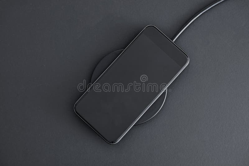 Induction Wireless Charging of Mobile Phone. High Angle View of ...