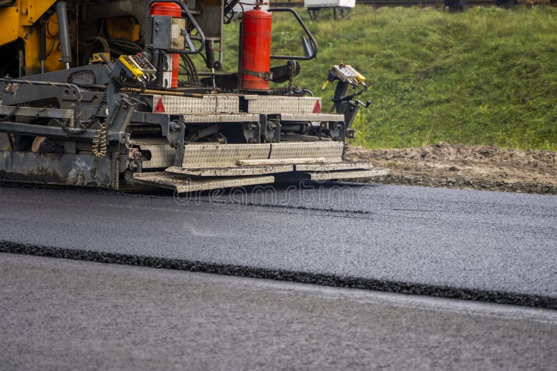 Industrial Asphalt Paver Machine Laying Fresh Asphalt on Road ...