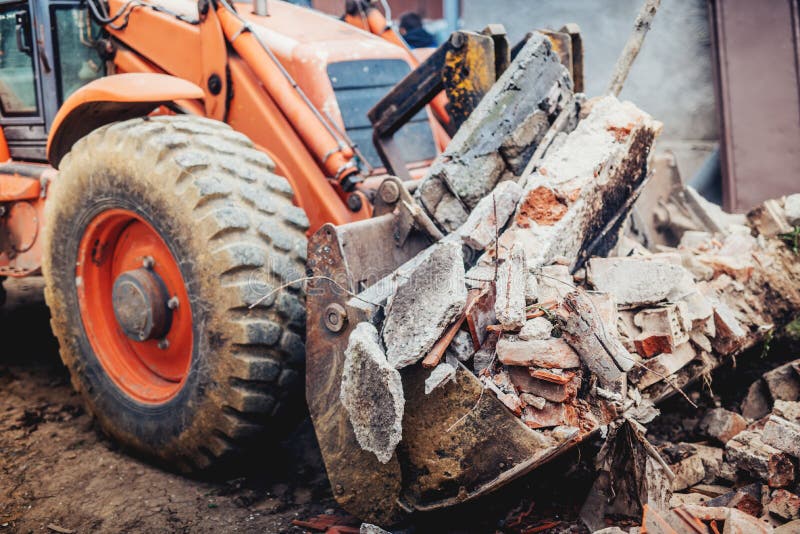 Backhoe Excavator Using Scoop and Blade for Loading Demolition Debris ...
