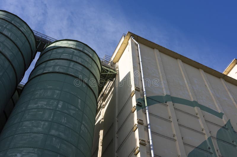 Industrial Bakery with Grain Silos and Building Under a Clear Blue Sky ...