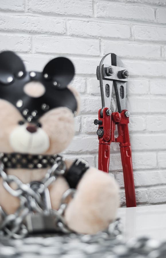 Industrial Bolt Cutter on the Background of a Teddy Bear Dressed in ...