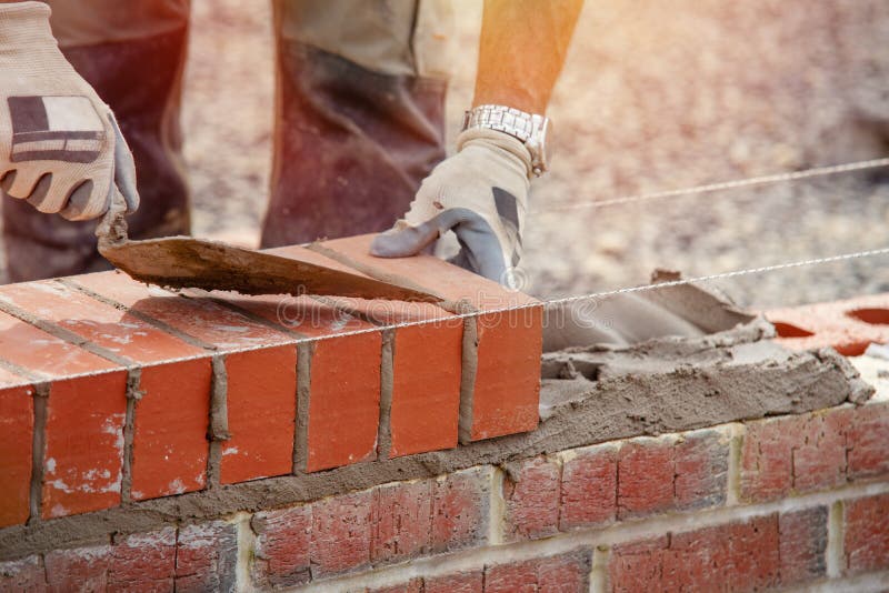 Industrial Bricklayer Laying Bricks on Cement Mix Stock Image - Image ...