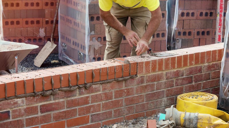 Industrial Bricklayer Laying Bricks on Cement Mix Stock Photo - Image ...
