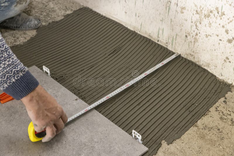 Industrial Ceramic Builder Worker Installing Floor Tile at Repair ...