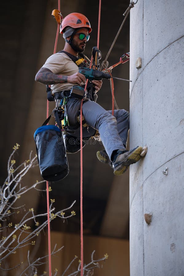 Rope Access Technician Working at Height with Power Drill Stock Photo ...