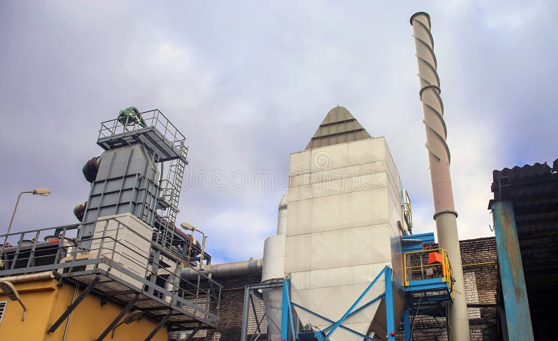 Industrial Complex Against a Cloudy Sky with a Large Exhaust Stack ...