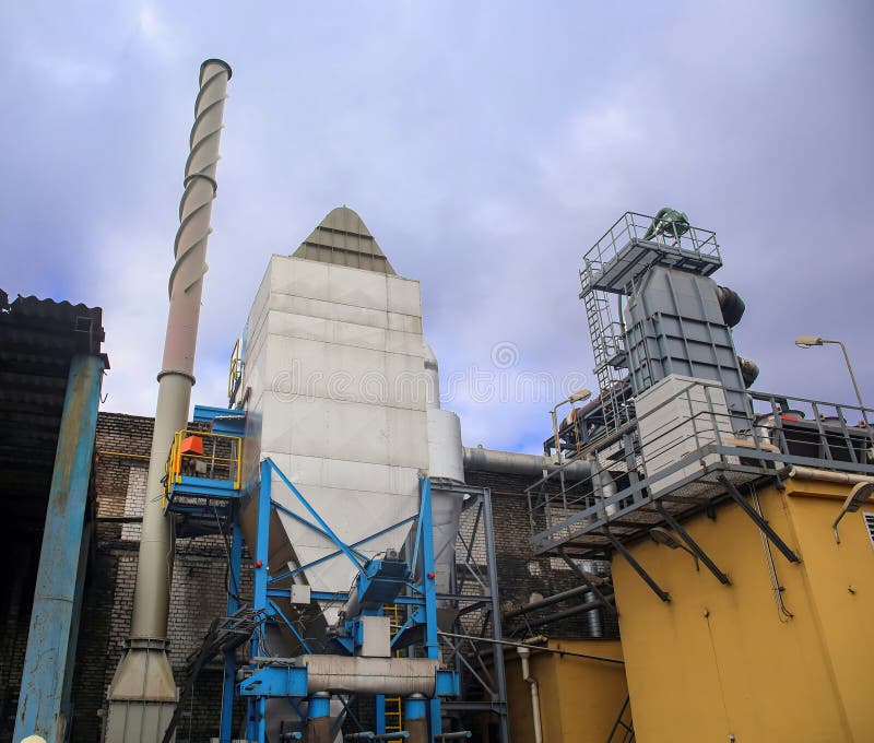 Industrial Complex Against a Cloudy Sky with a Large Exhaust Stack ...