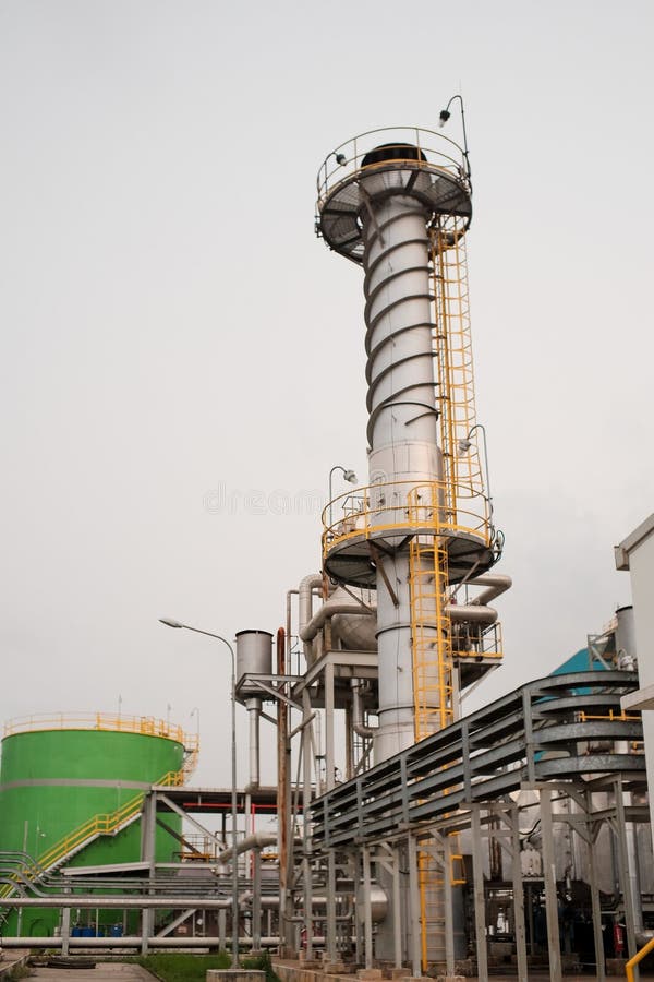 Industrial Complex Landscape with Towering Structure Against Pale Sky ...
