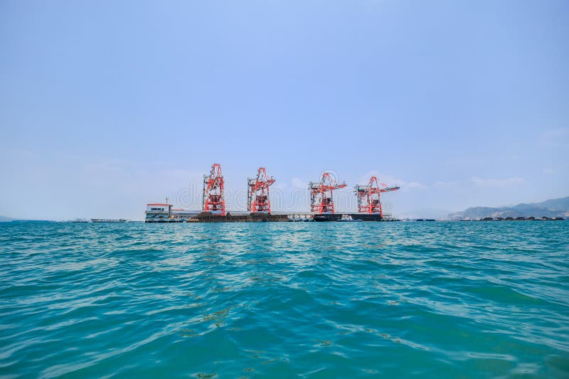 Industrial Crane Unloading Coal from a Barge for Power Plant Operations ...