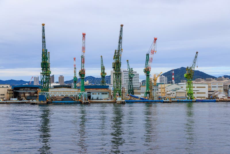 Industrial Cranes at Cargo Loading Dock at Quiet Harbor on Cloudy Day ...