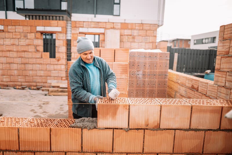 Construction Bricklayer Worker Building Walls with Bricks, Mortar and ...