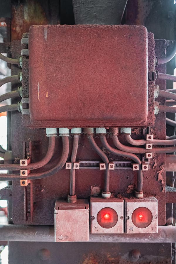 Industrial Electrical Box with Cables and Glowing Red Lights in Rusty ...