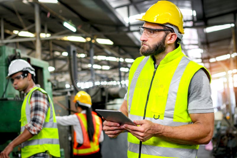 Industrial Engineer with Helmet and Safety Vest Holds Tablet for ...