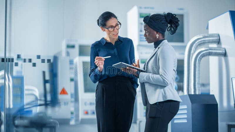 Industrial Engineer Talks with Project Supervisor, they Use Digital ...