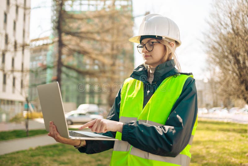 Industrial Engineer Woman in Working Uniform Connected with Smart PC ...