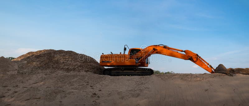 Industrial Excavator is Digging the Sand in the Riverside on the Blue ...