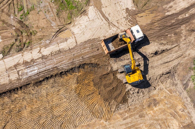 Industrial Excavator Loading Ground into a Dump Truck on Construction ...
