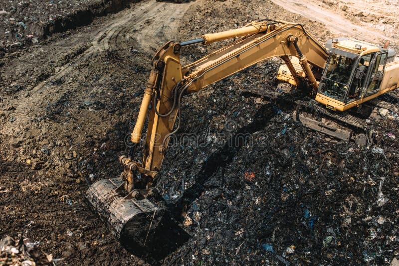 Industrial Excavators Working on Garbage Dump. Heavy Duty Machinery at ...