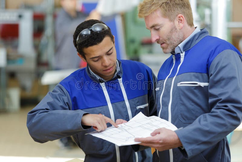 Industrial Factory Workers Studying Blueprint Stock Photo - Image of ...