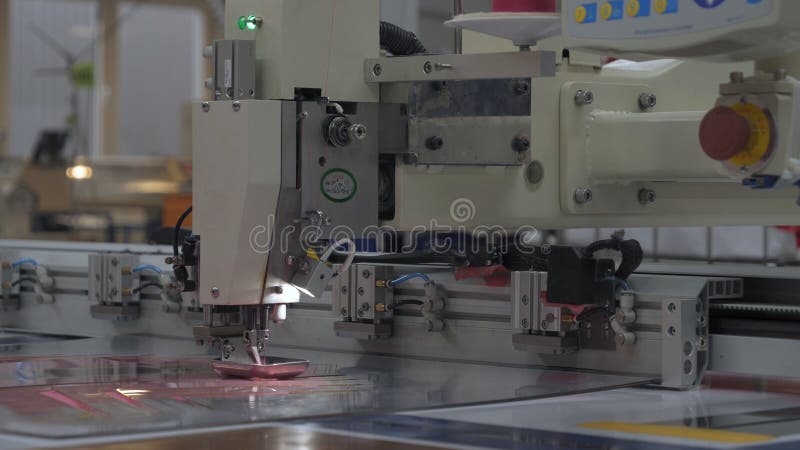 In an Industrial Garment Factory, an Automatic Sewing Machine Sews ...