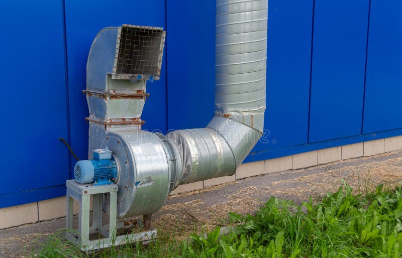 Industrial Grade Air Extraction Duct with Electrical Motor on Blue Wall ...