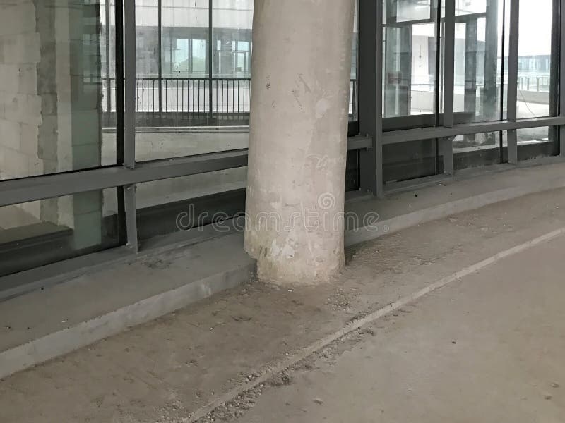 An Industrial Interior Shows a Support Column and Large Windows in a ...