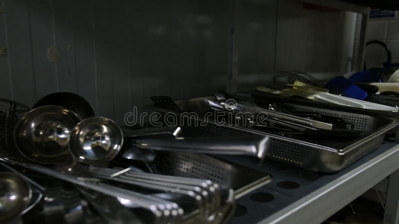 Industrial Kitchen Utensils Arranged on Shelves in a Commercial ...